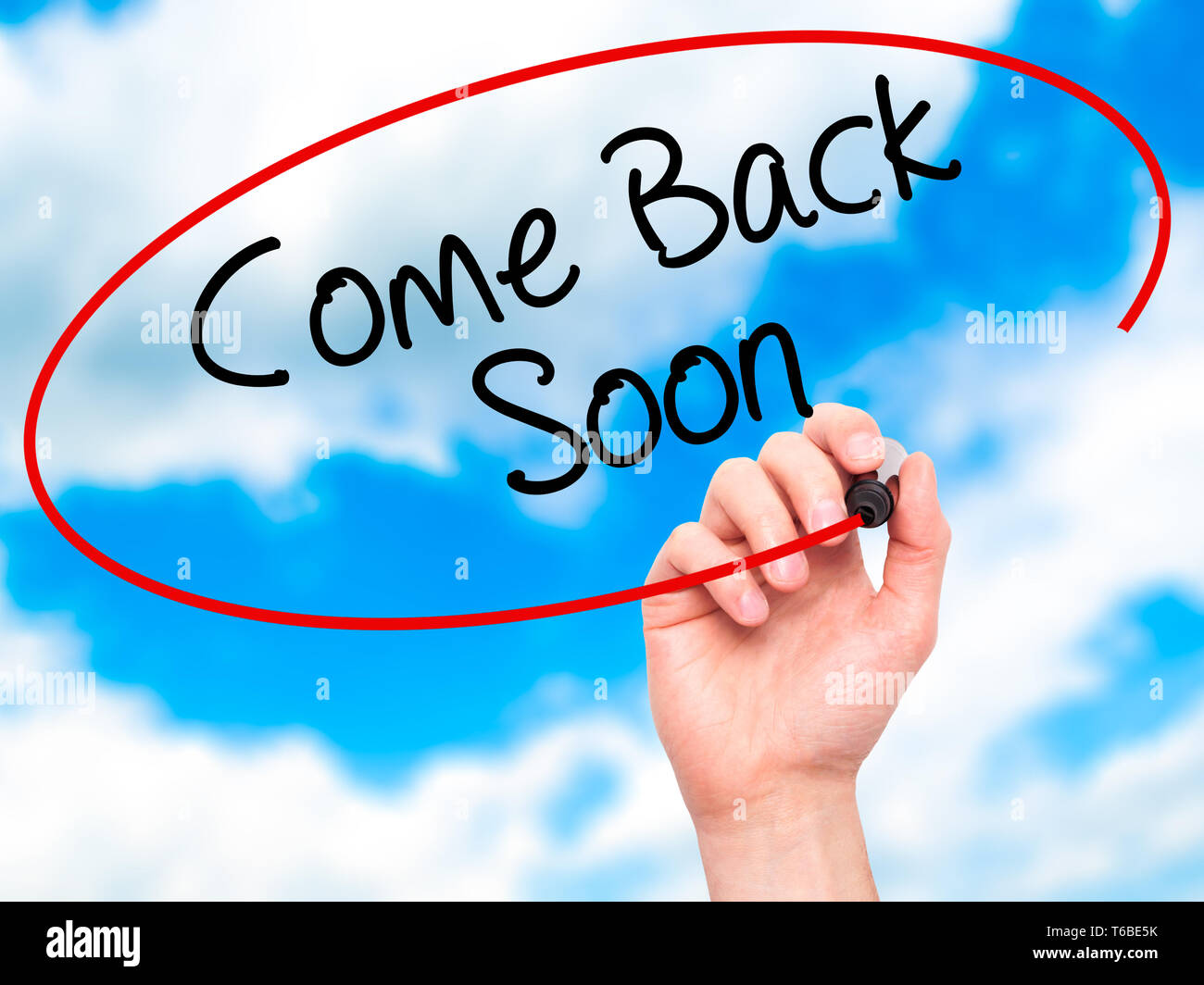 Man Hand writing Come Back Soon with black marker on visual screen ...