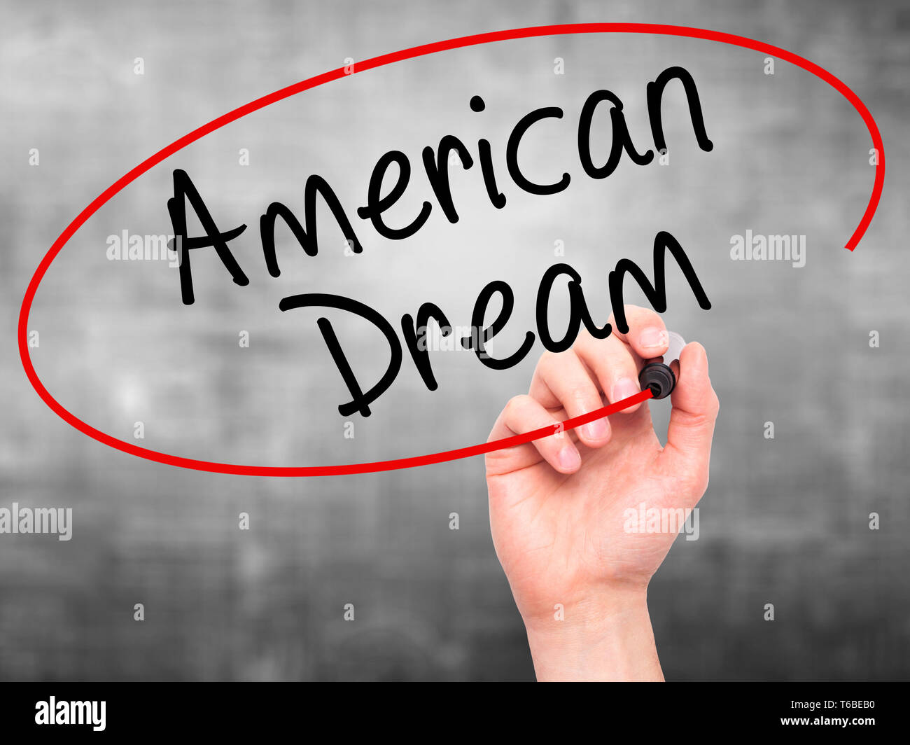 Man Hand writing American Dream with black marker on visual screen ...