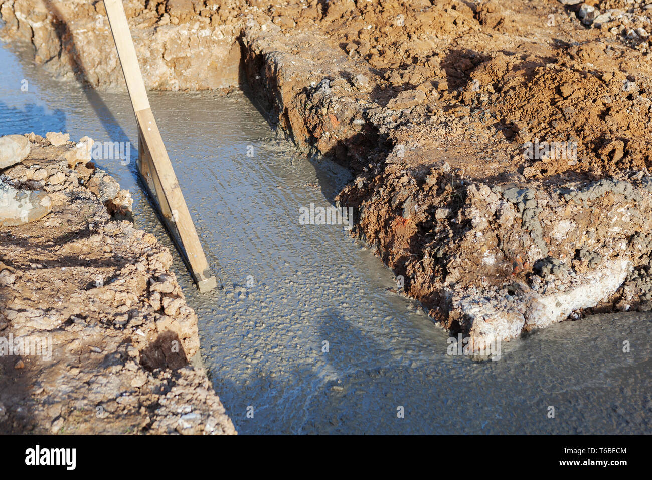 Dug trenches filled with concrete, preparations of foundations for the ...