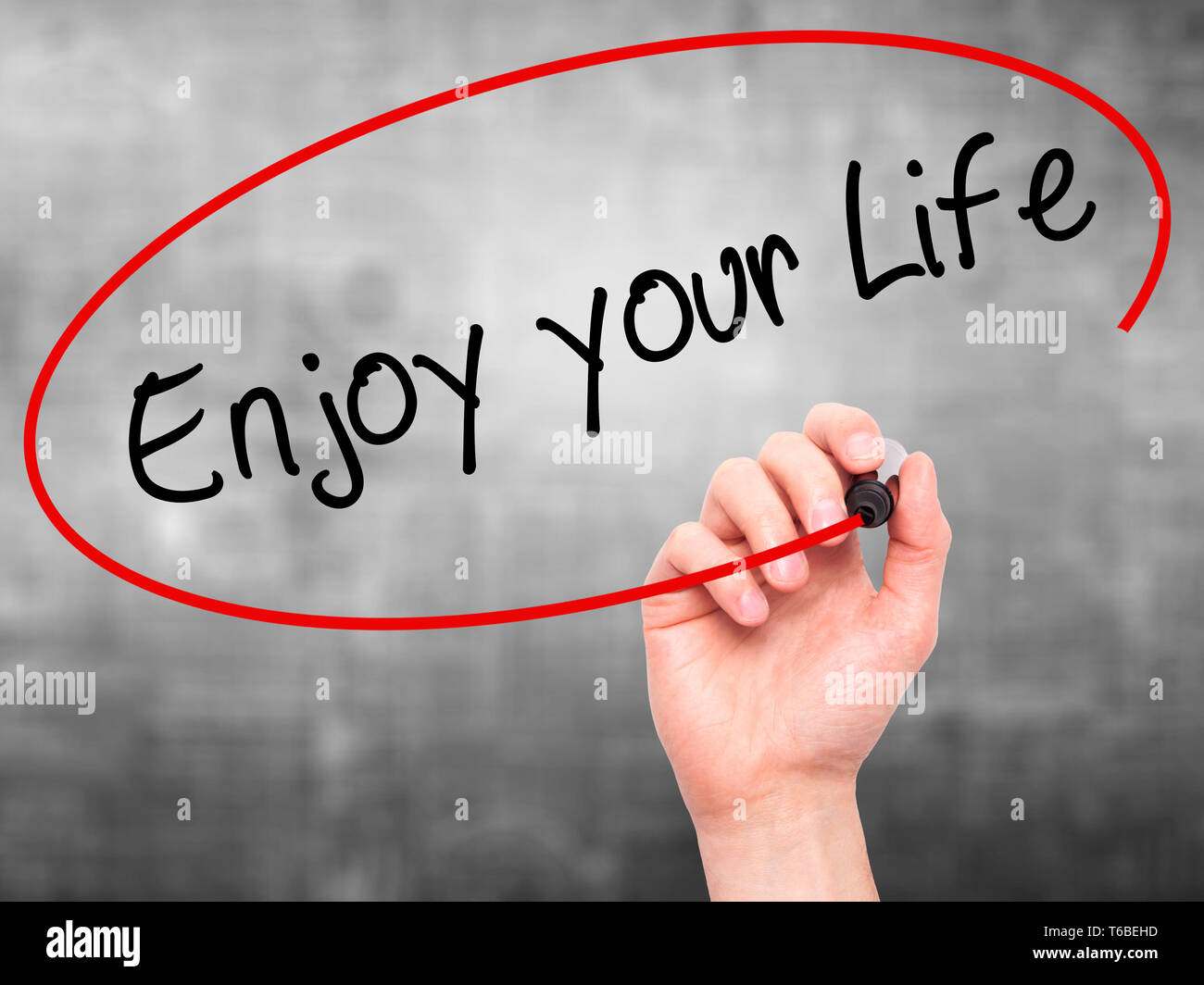 Man Hand writing Enjoy your Life with black marker on visual screen ...