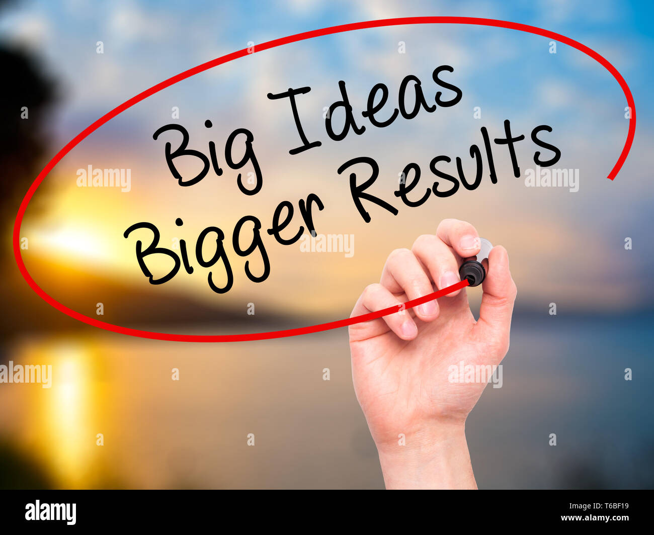 Man Hand writing Big Ideas Bigger Results with black marker on visual ...