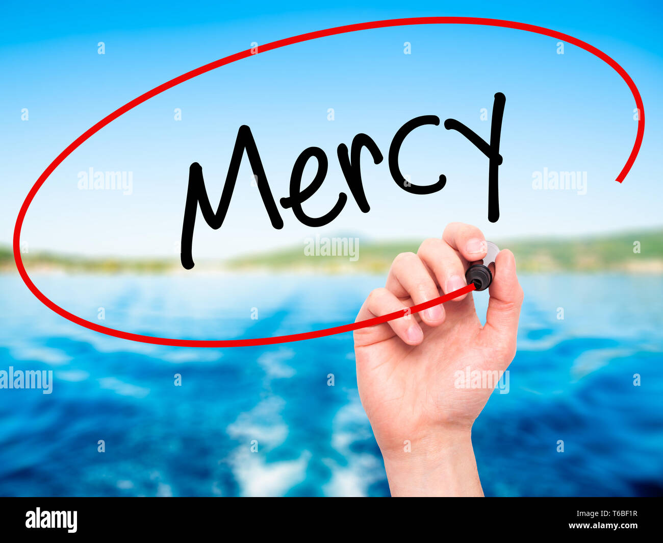 Man Hand writing Mercy with black marker on visual screen Stock Photo ...