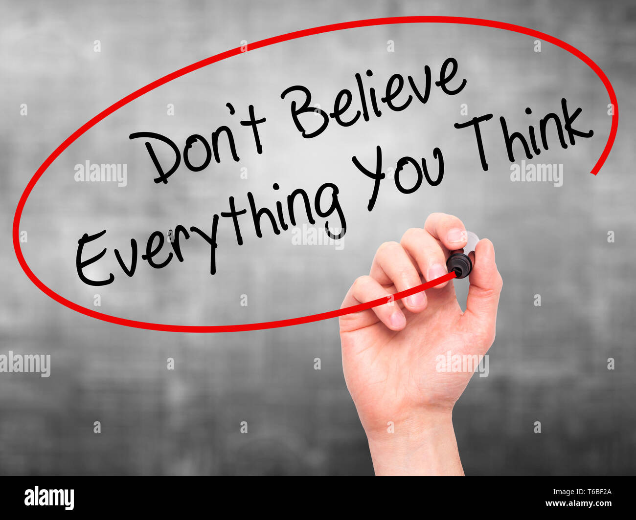 Man Hand writing Don't Believe Everything You Think with black marker ...