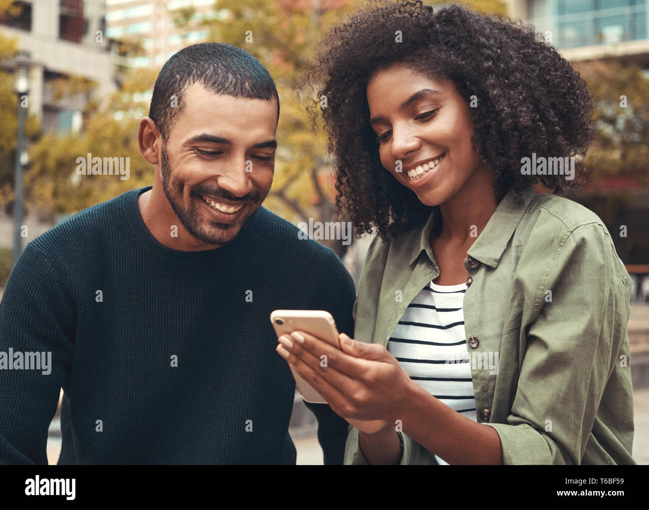 Beautiful young couple using mobile hi-res stock photography and images ...