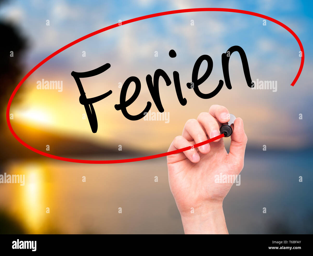 Man Hand writing Ferien (Vacation in German) with black marker on ...