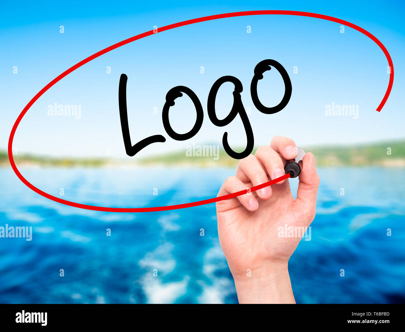 Man Hand writing Logo with black marker on visual screen Stock Photo ...