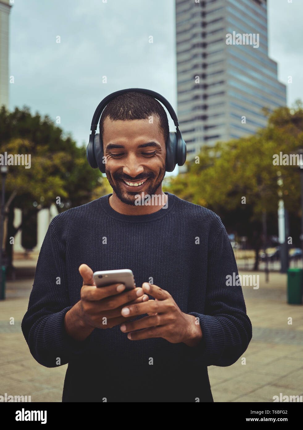 Young man watching video using mobile phone Stock Photo - Alamy
