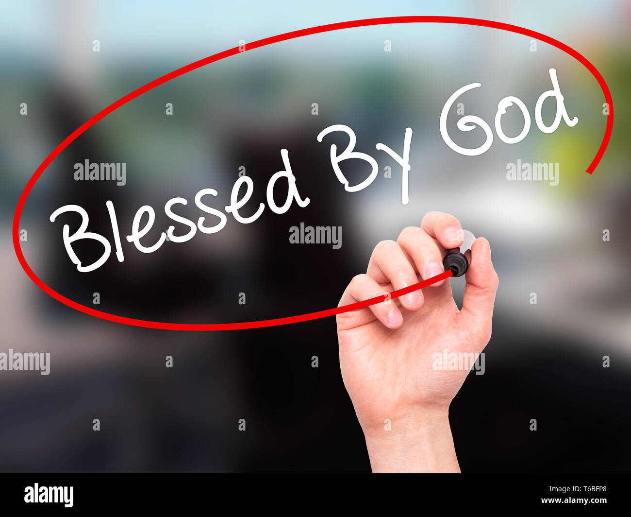 Man Hand writing Blessed By God with black marker on visual screen ...