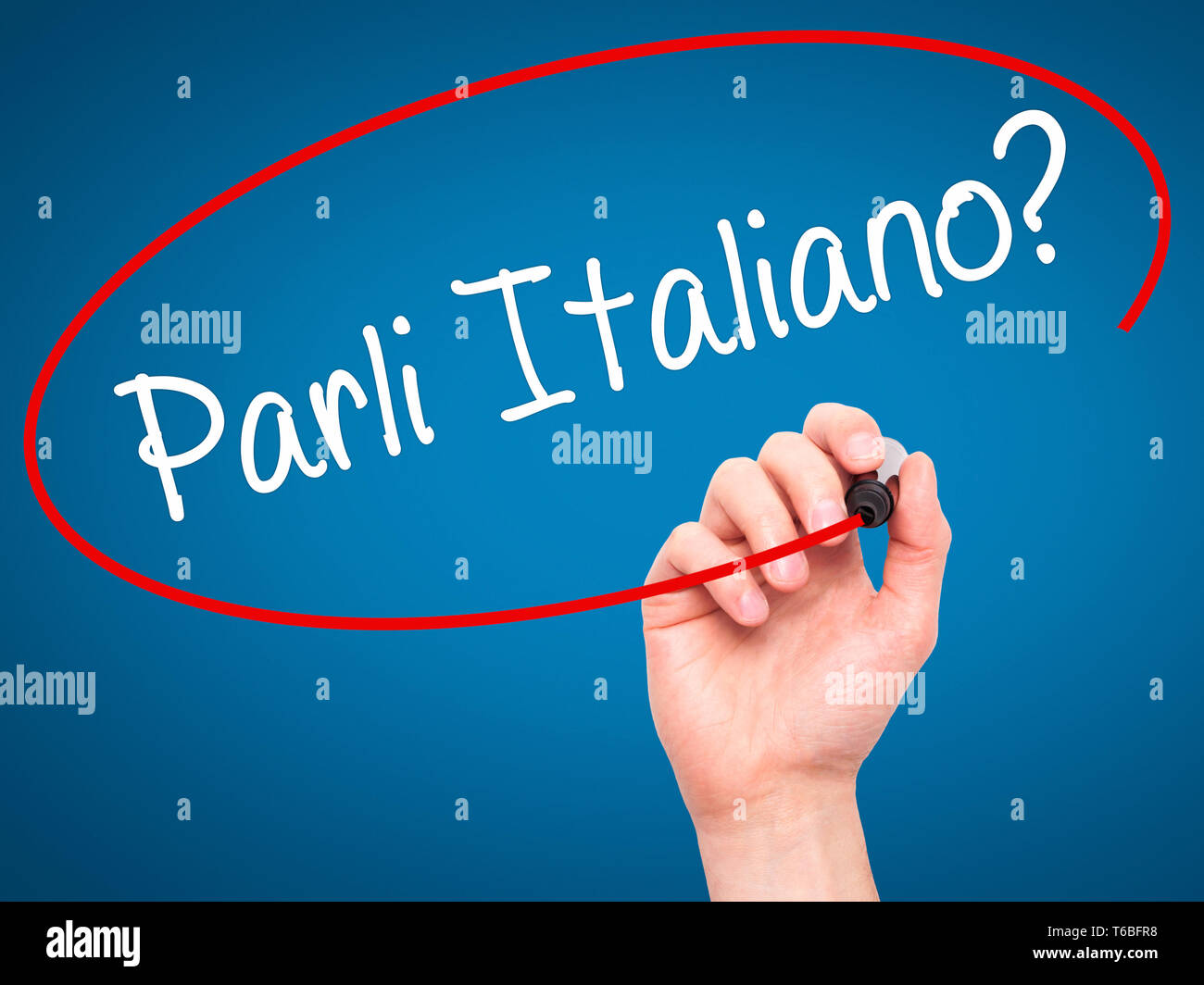 Man Hand writing Parli Italiano? with black marker on visual screen ...