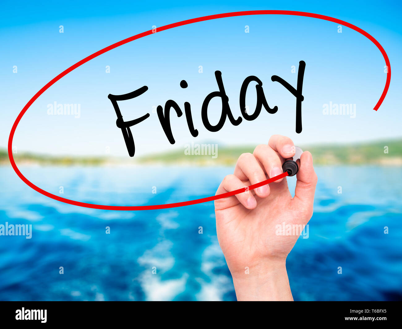 Man Hand writing Friday with black marker on visual screen Stock Photo ...