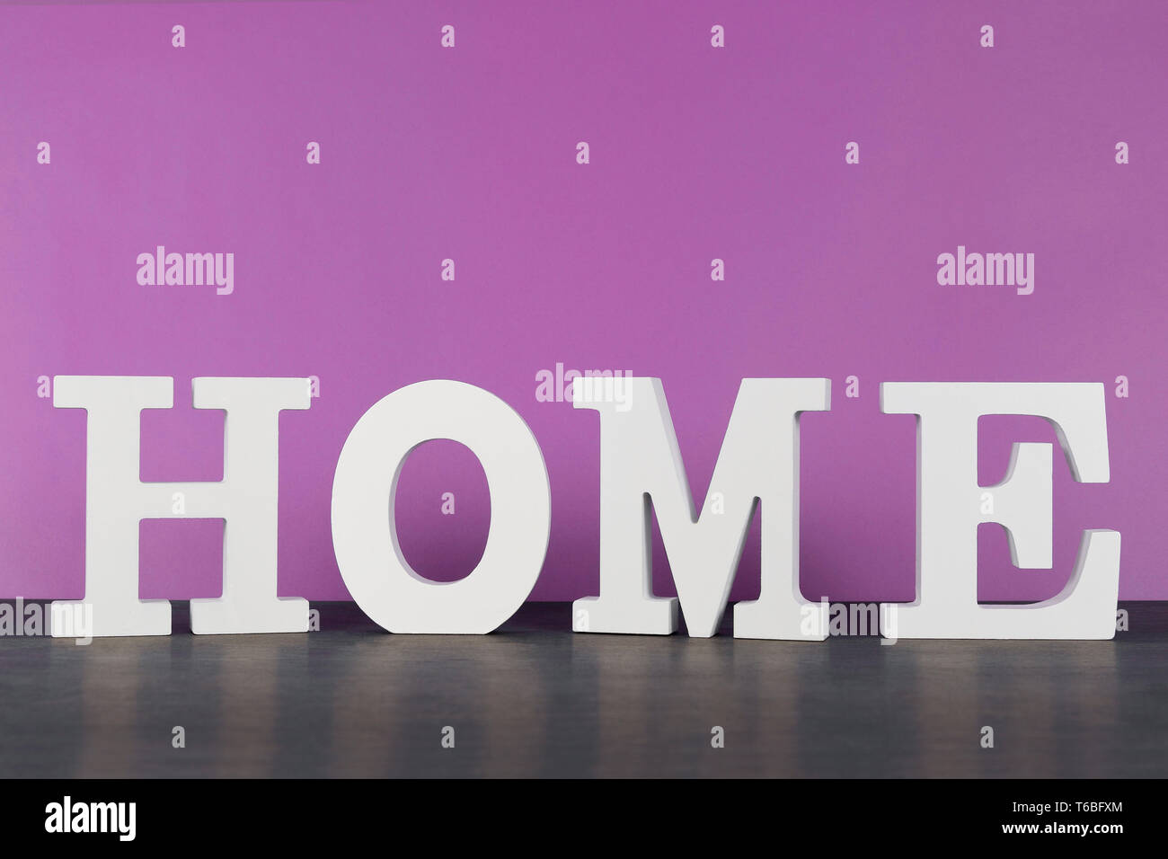 Home, written in letters, with pink wall paint Stock Photo - Alamy