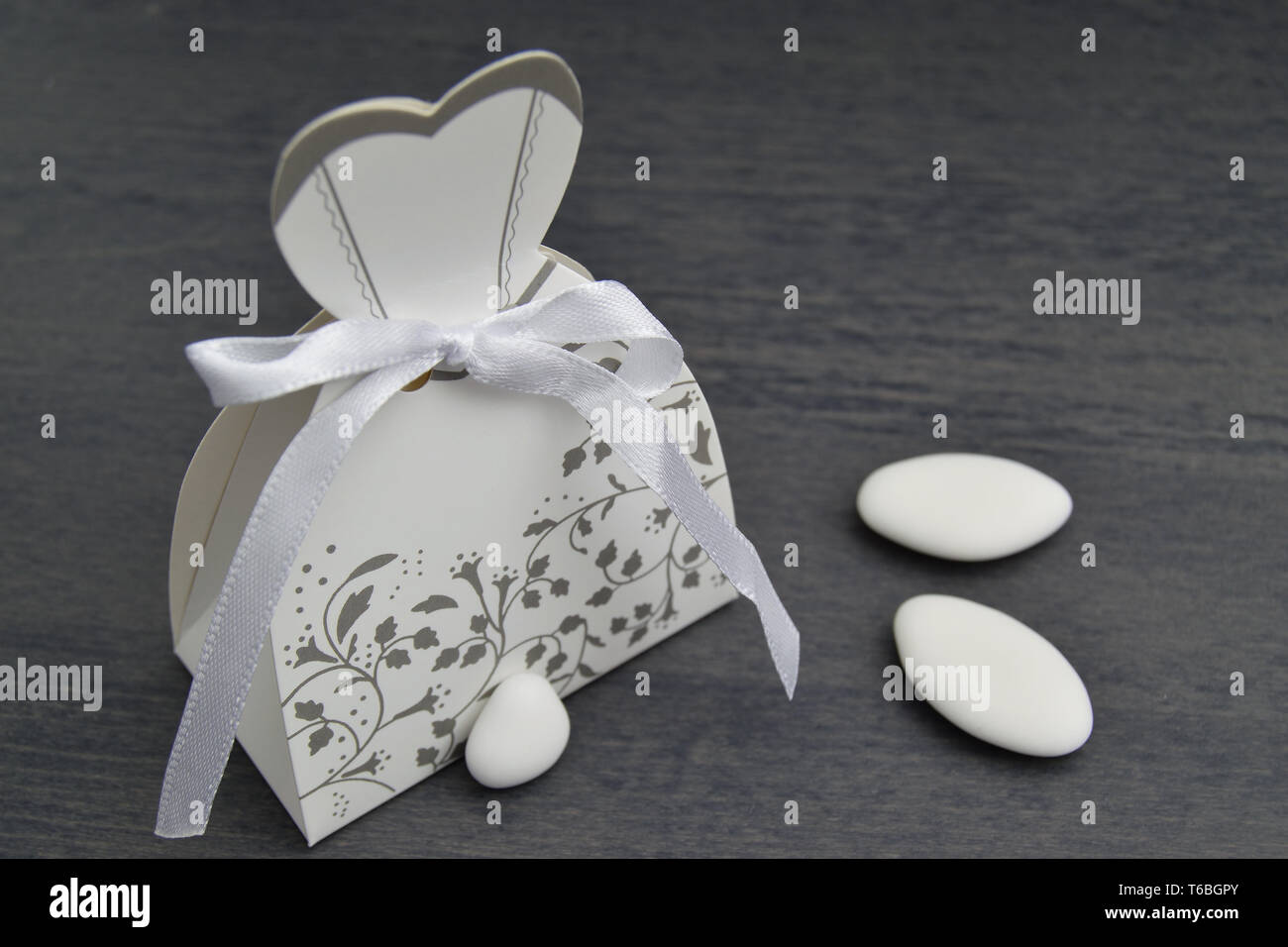 wedding dress shaped box with almond confetti inside Stock Photo - Alamy