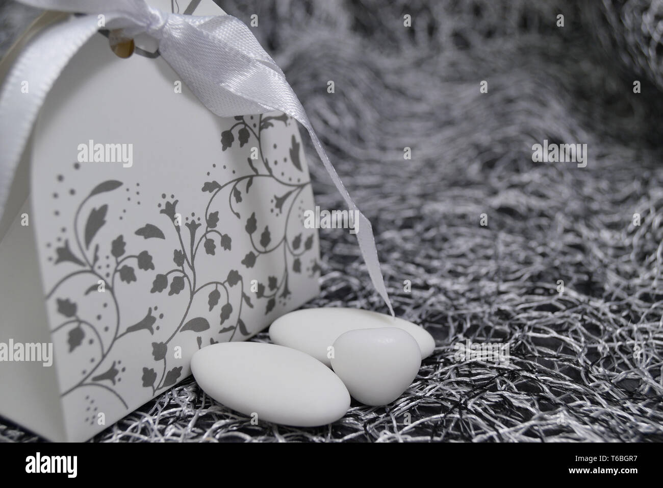 wedding dress shaped box with almond confetti inside Stock Photo - Alamy