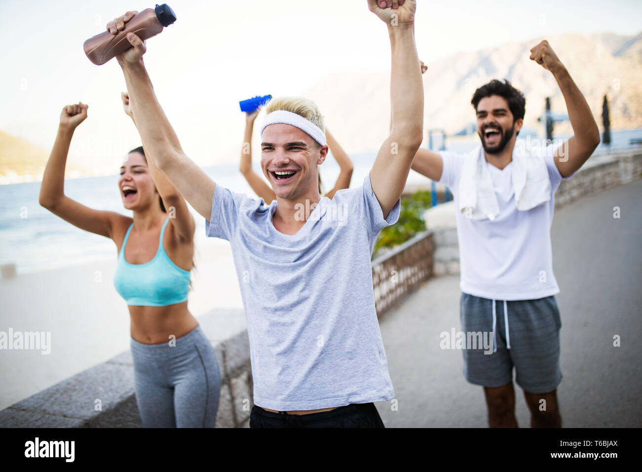 Outdoor portrait of group of friends running and jogging in nature ...