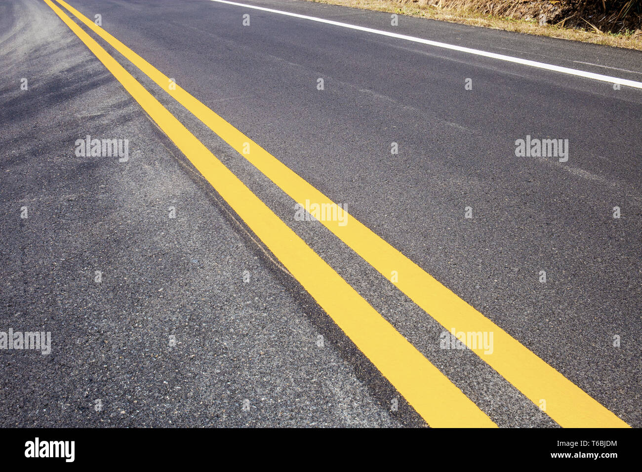 Traffic lines on rural roads with texture background Stock Photo - Alamy