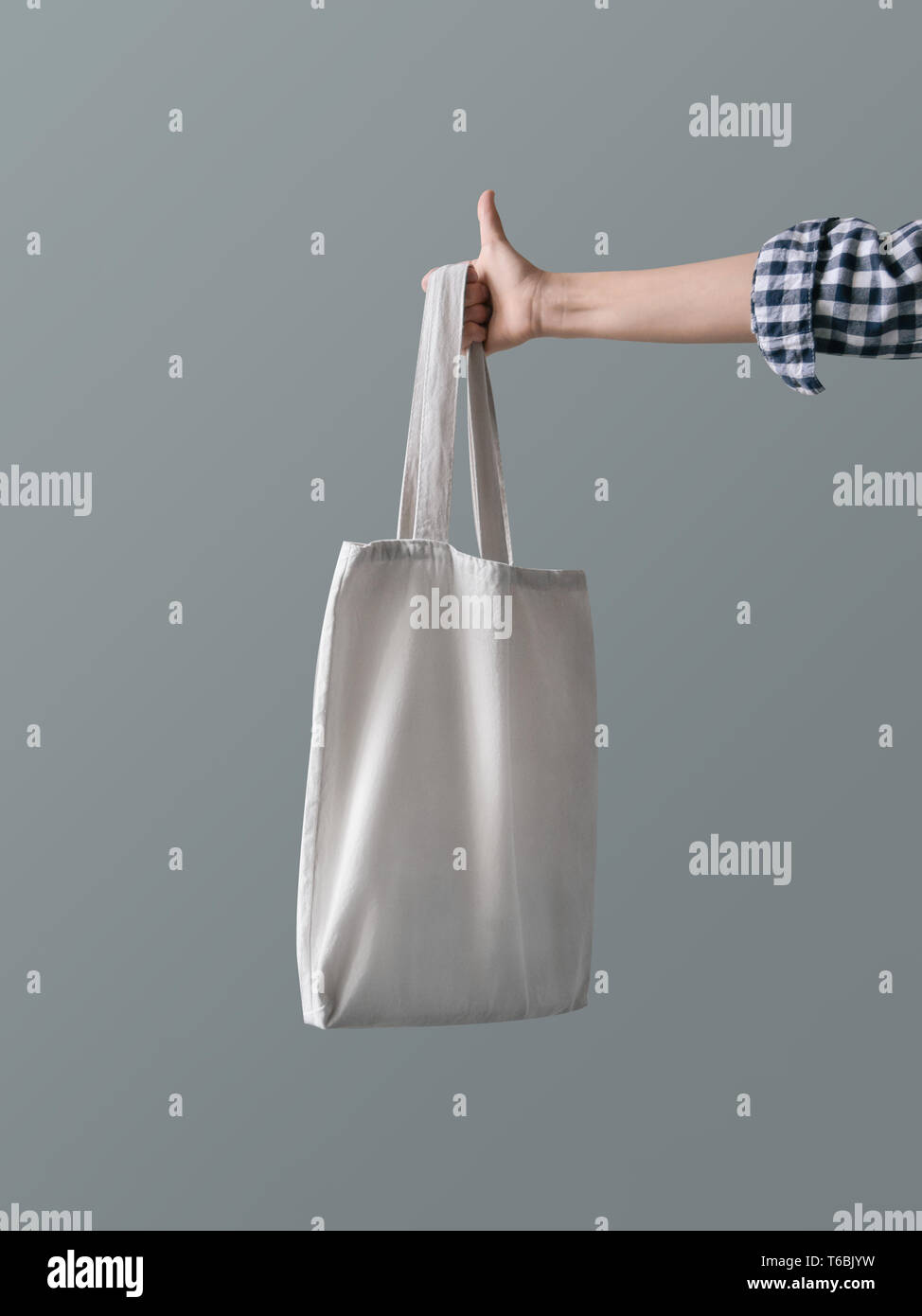 Blank canvas tote bag Eco product A woman is holding a reusable white ...