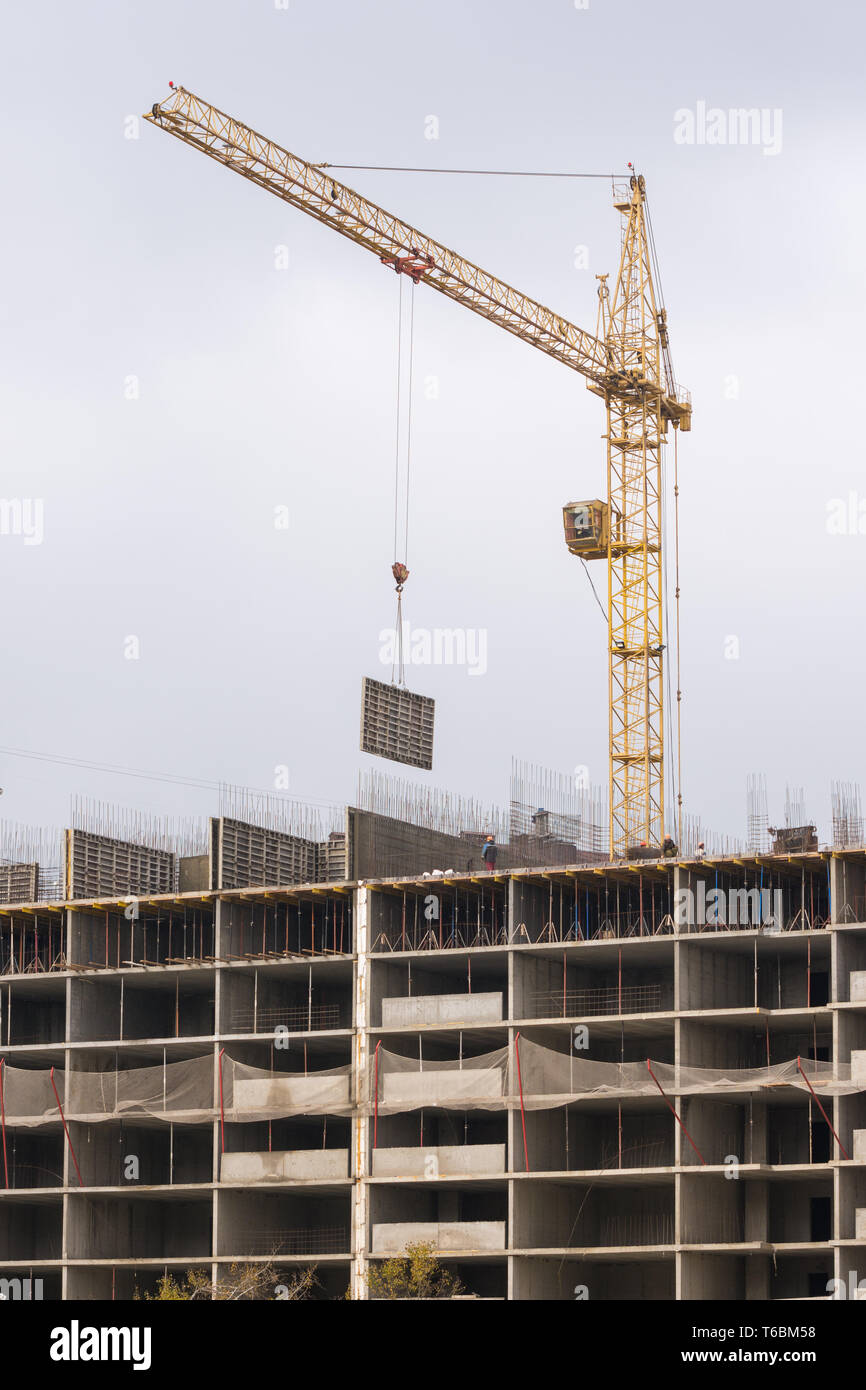 Crane raised formwork on construction of multi-storey residential ...