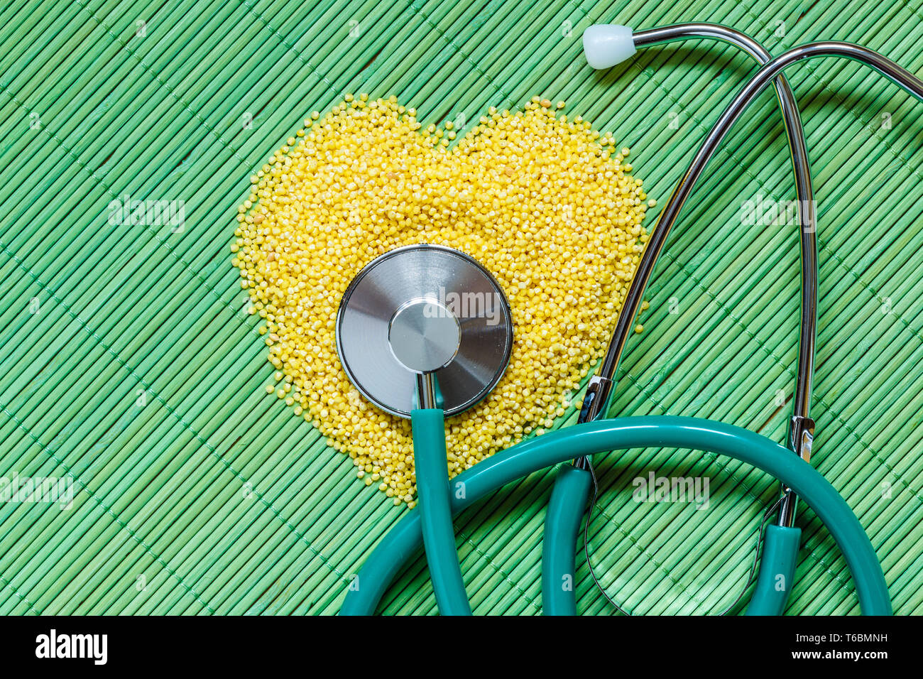 Dieting healthy living concept. Millet groats heart shaped and ...