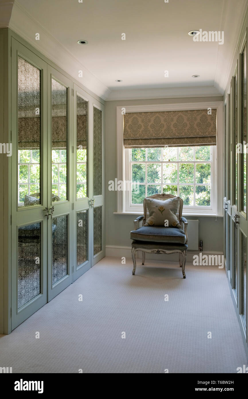Elegant armchair and wardrobes Stock Photo - Alamy