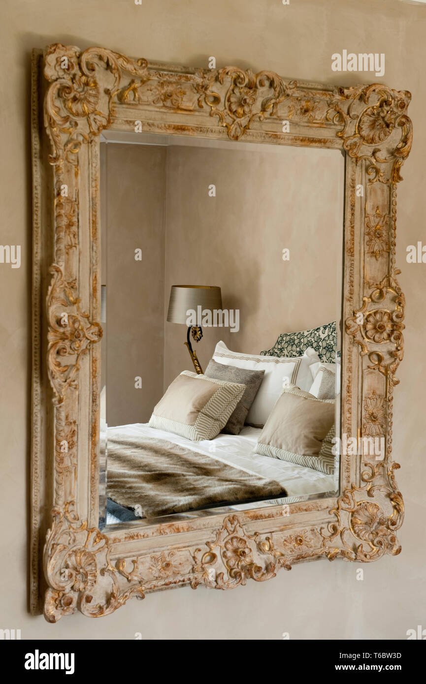 Bed reflected in an old fashioned mirror Stock Photo - Alamy