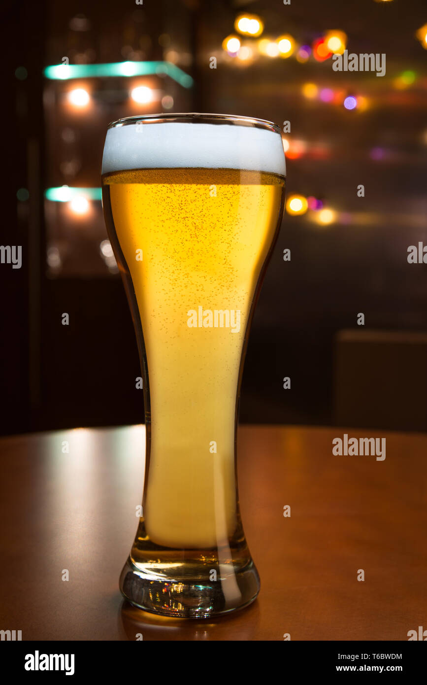 Tall glass of beer in bar Stock Photo - Alamy