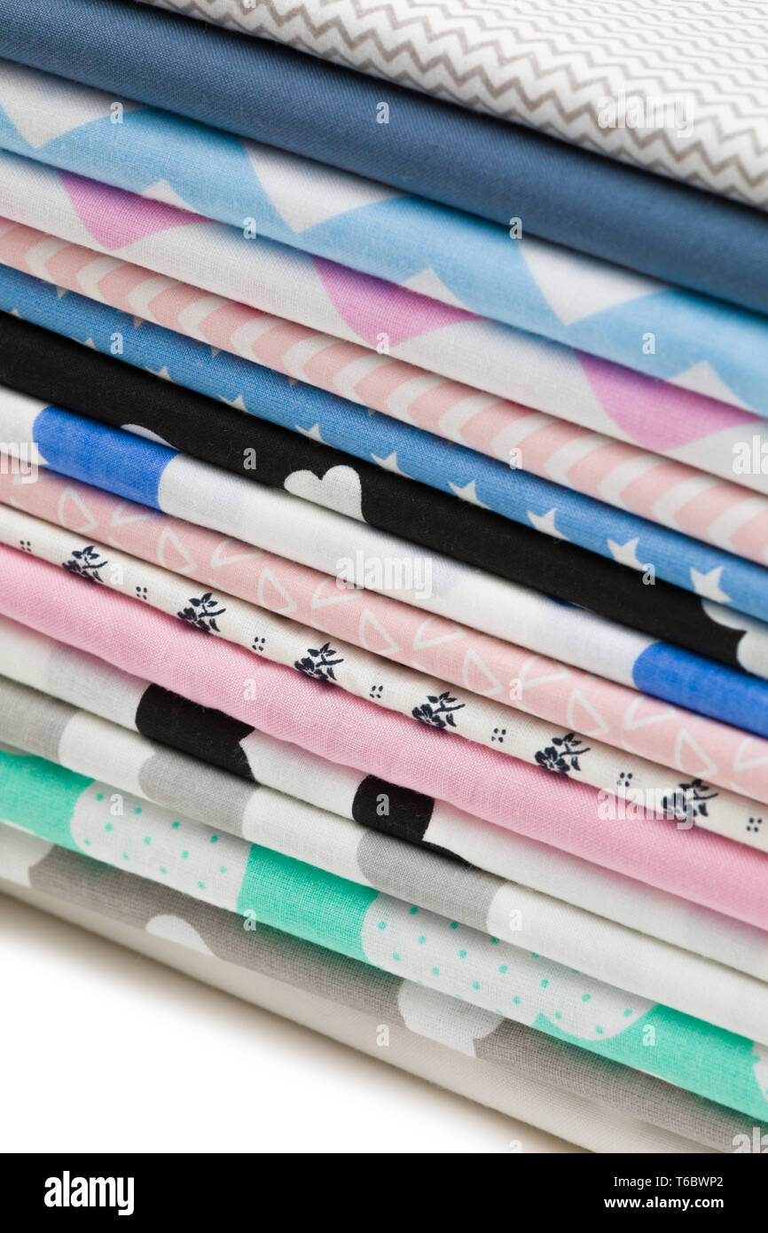 Stack of cotton fabric material isolated on white Stock Photo - Alamy