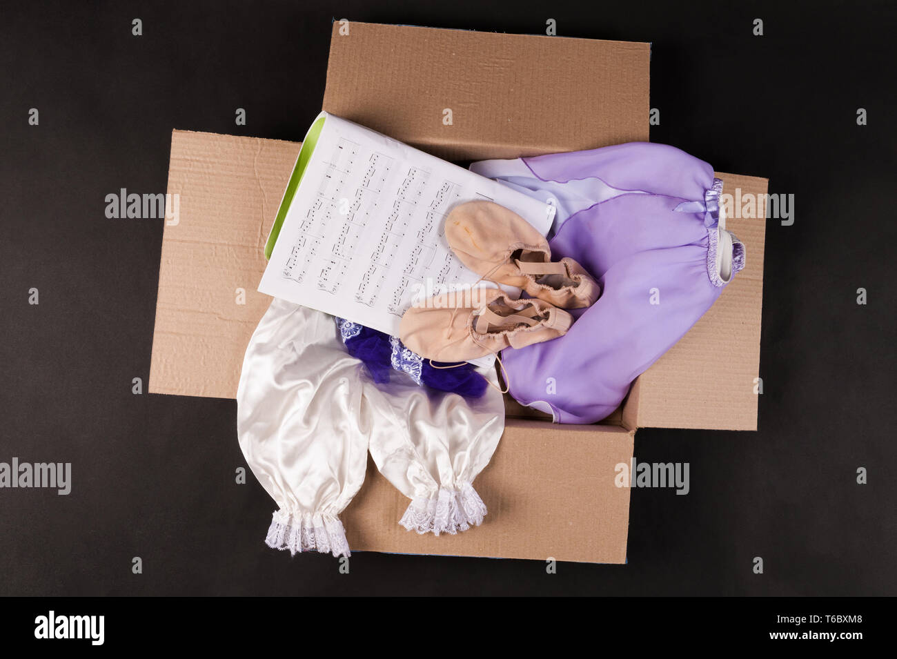 cardboard box with clothes for dancing on dark background Stock Photo ...