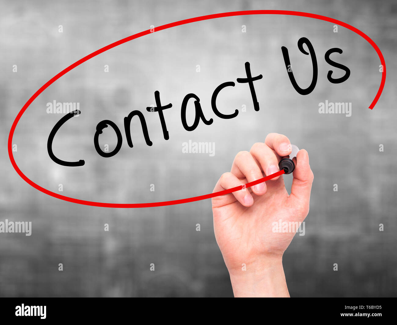 Man Hand writing Contact Us with marker on transparent wipe board ...