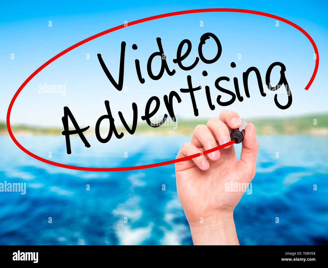 Man Hand writing Video Advertising with black marker on visual screen ...