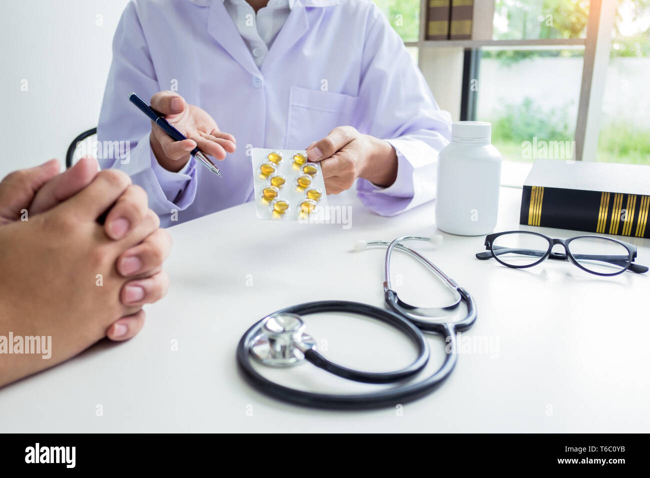 doctor hand holding tablet of drug and explain to patient in hospital ...