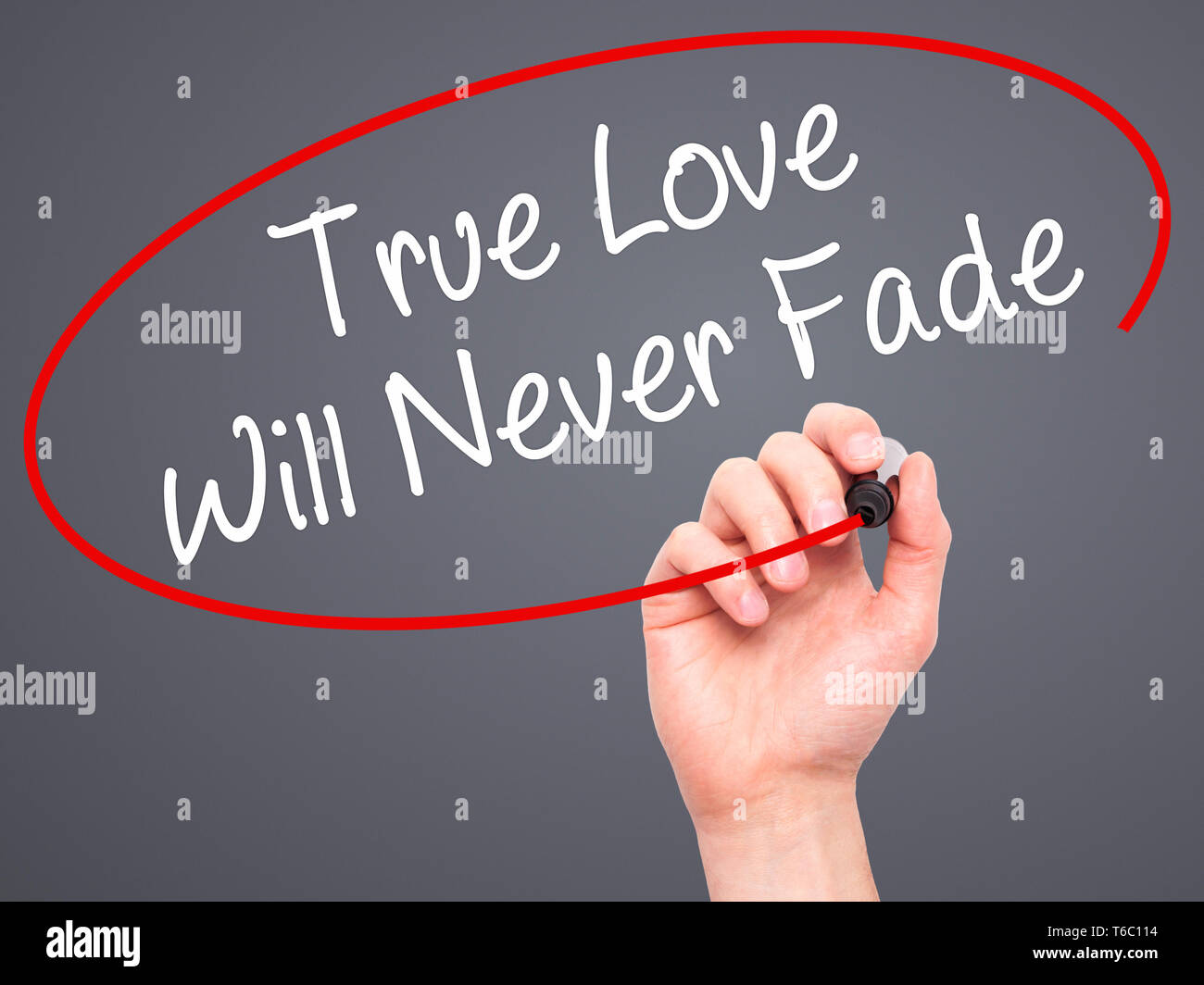 Man Hand writing True Love Will Never Fade with black marker on visual ...
