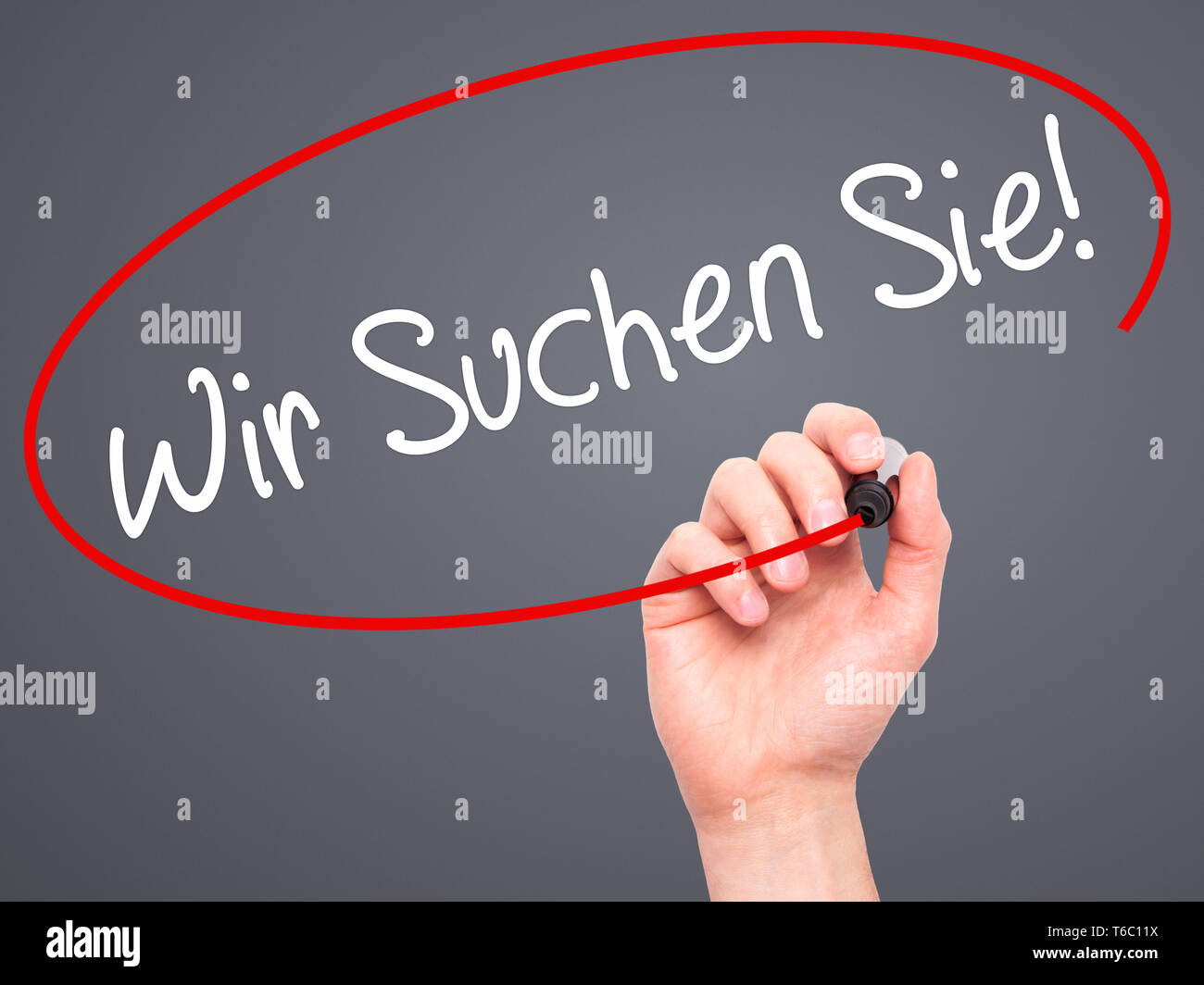 Man Hand writing Wir Suchen Sie! (Looking For You in German) with black ...