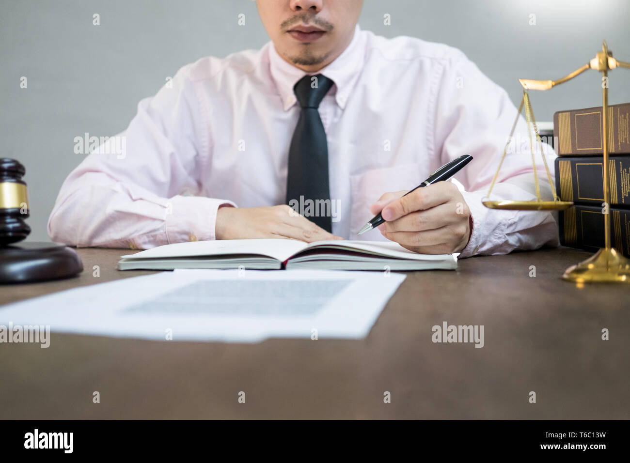 lawyer judge reading documents at desk in courtroom working on wooden ...