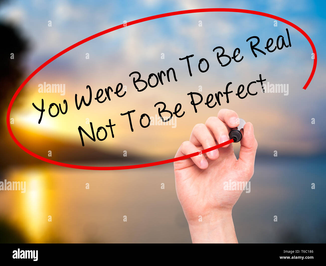 Man Hand writing You Were Born To Be Real Not To Be Perfect with black ...