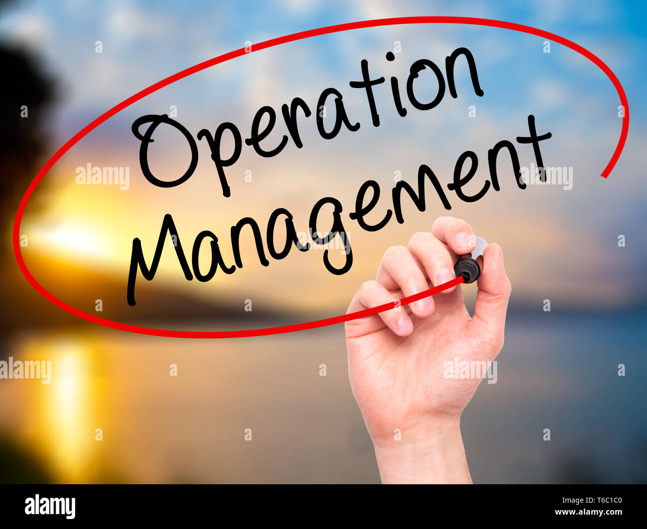 Man Hand writing Operation Management with black marker on visual ...