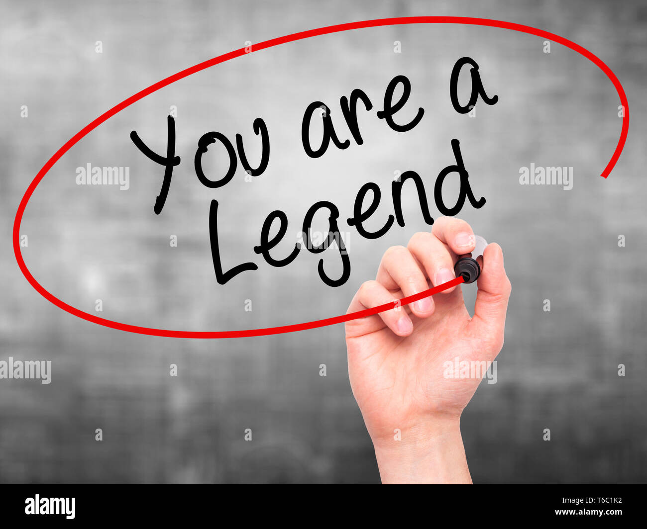 Man Hand writing You are a Legend with black marker on visual screen ...