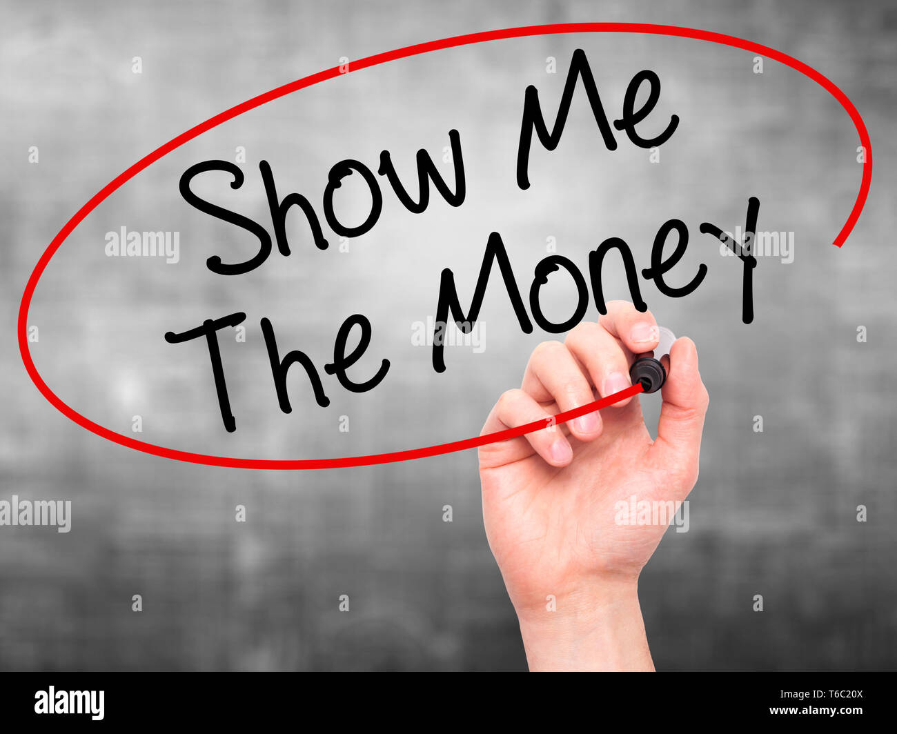 Man Hand writing Show Me The Money with black marker on visual screen ...