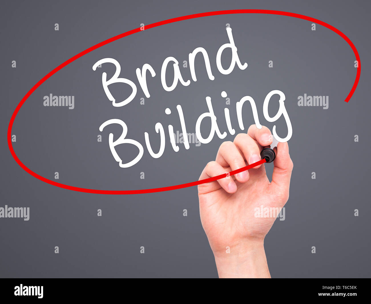Man Hand writing Brand Building with black marker on visual screen ...