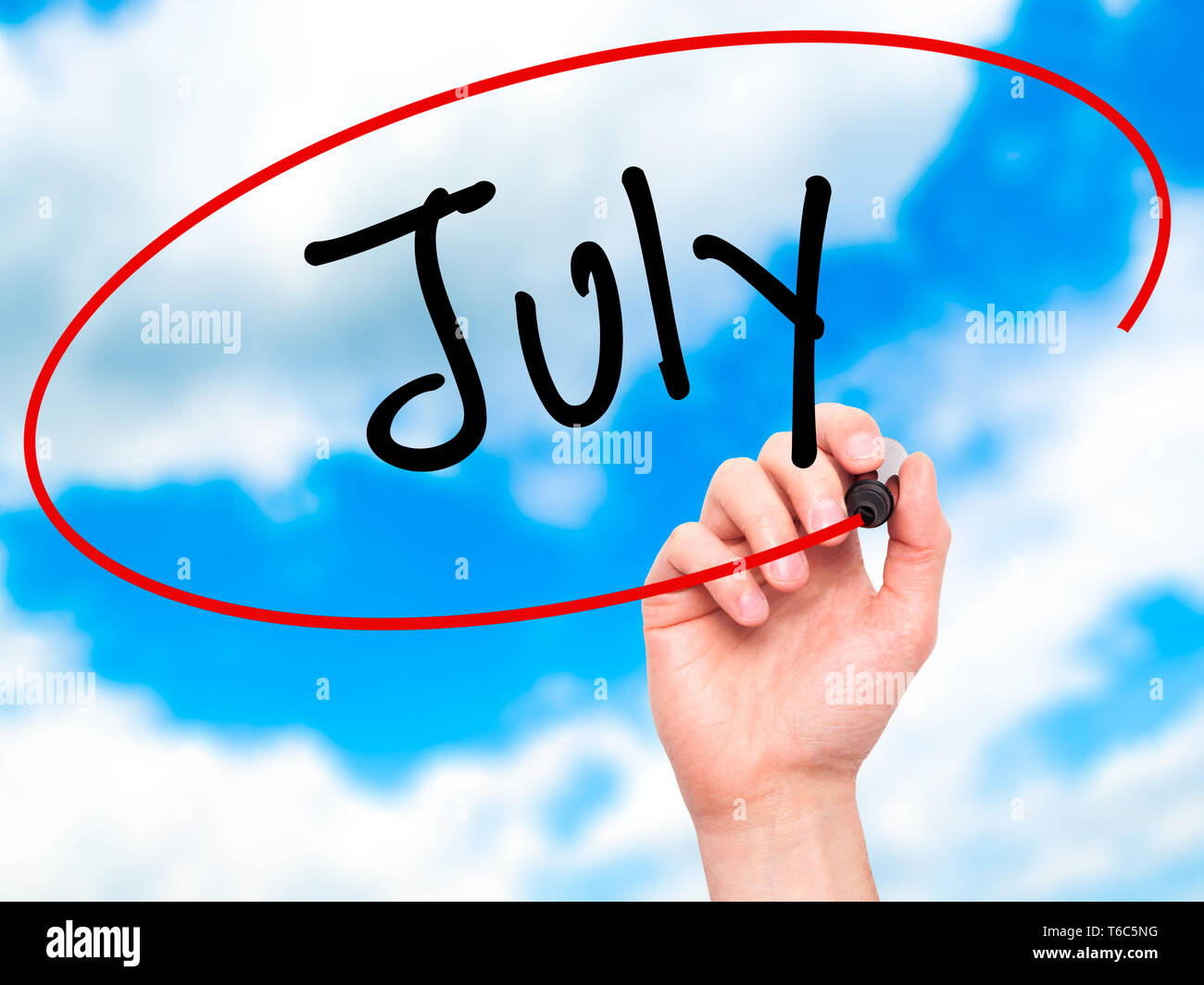 Man Hand writing July with black marker on visual screen Stock Photo ...