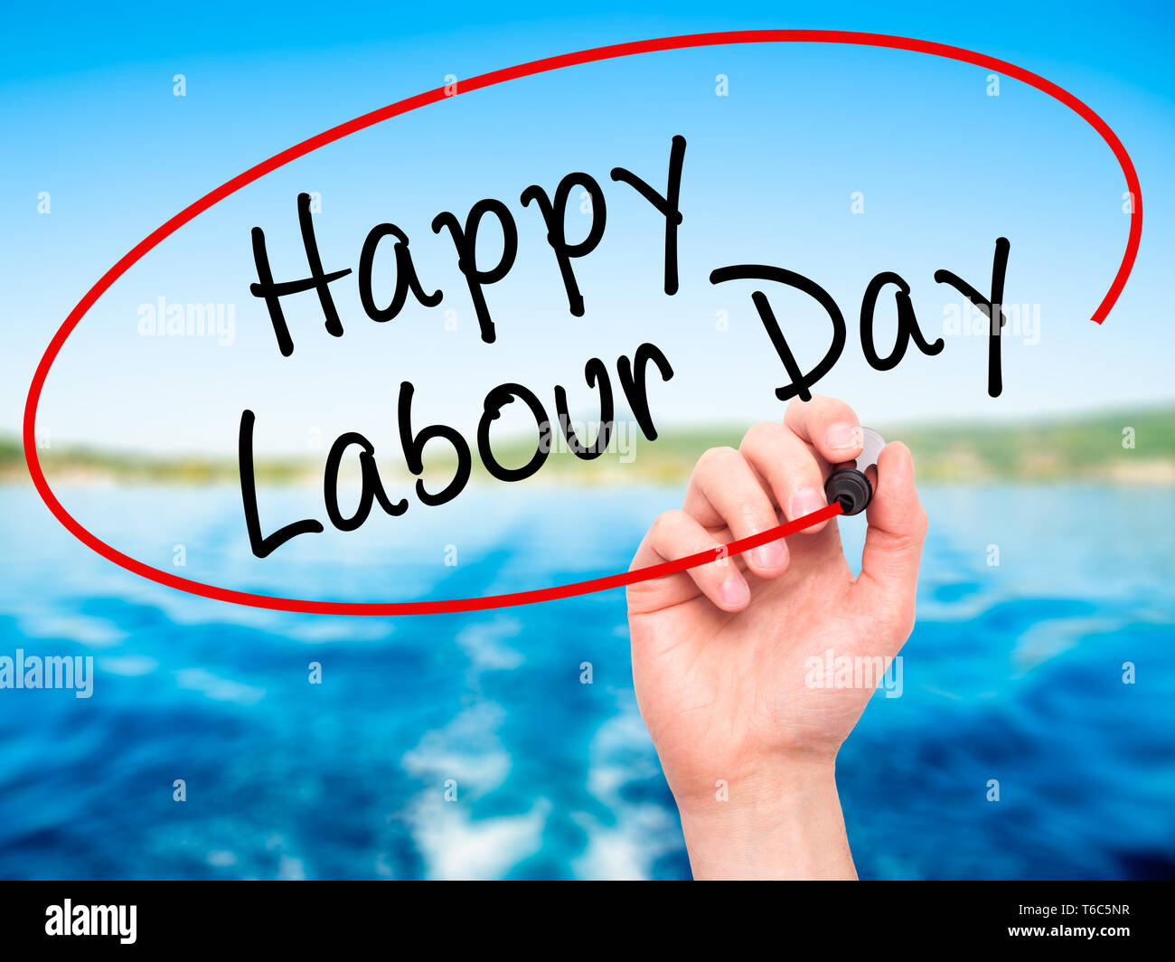 Man Hand writing Happy Labor Day with black marker on visual screen ...