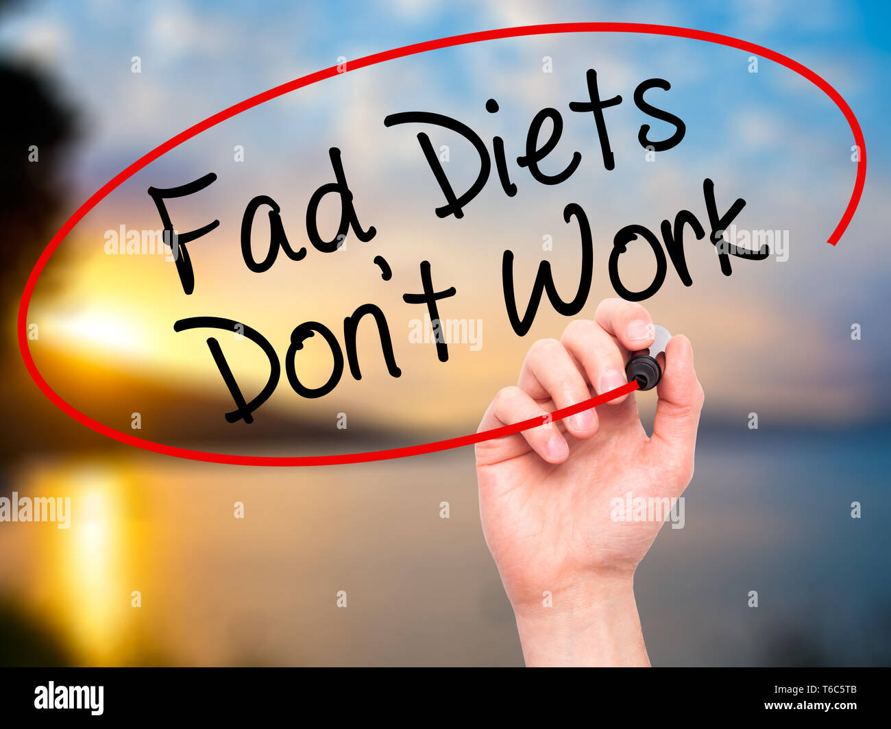 Man Hand writing Fad Diets Don't Work with black marker on visual ...