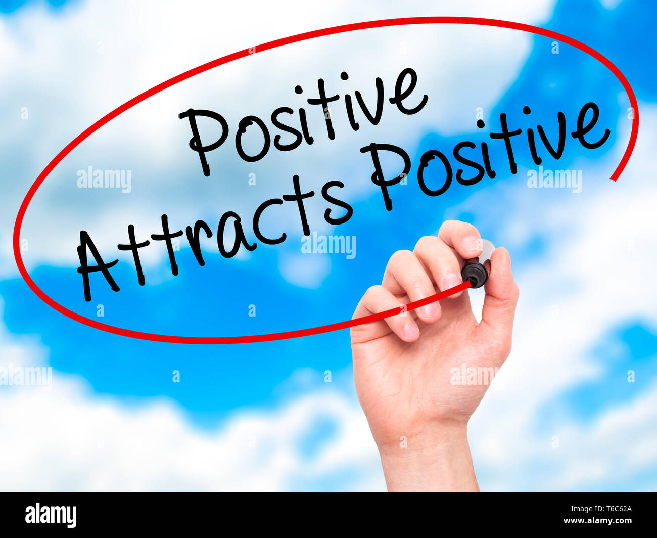 Man Hand writing Positive Attracts Positive with black marker on visual ...