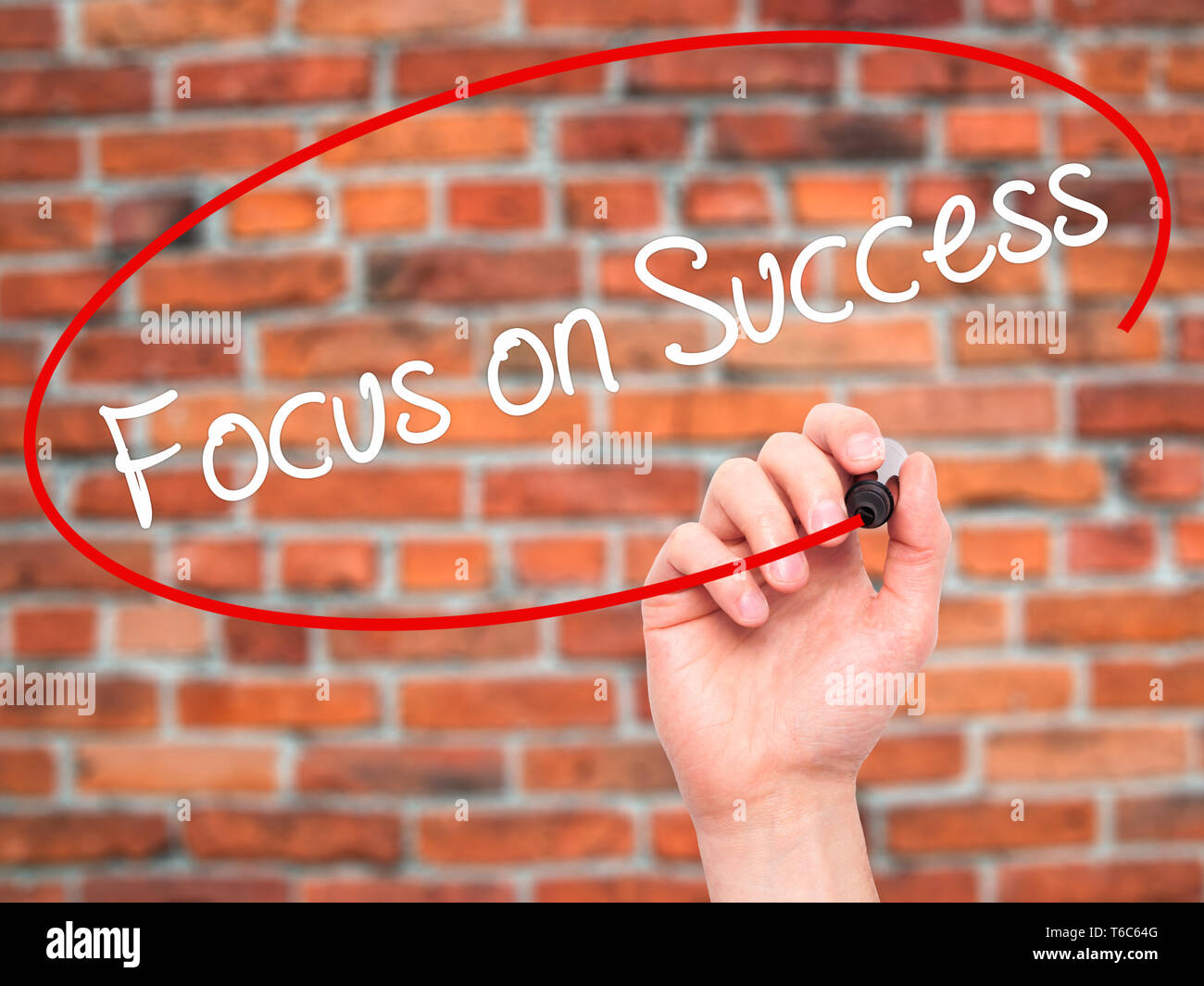 Man Hand writing Focus on Success with black marker on visual screen ...
