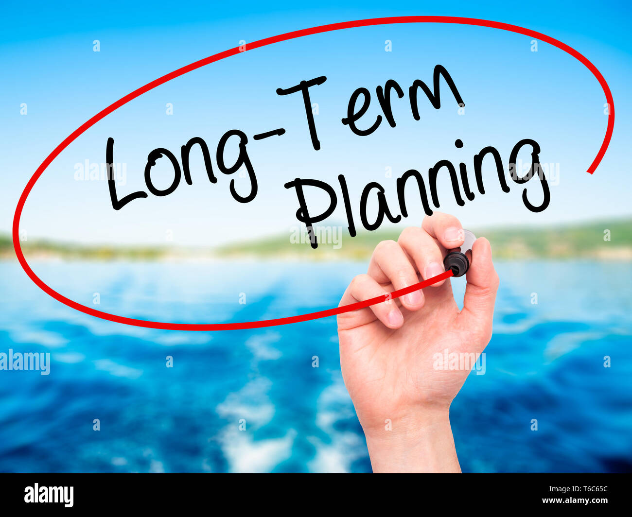 Man Hand writing Long-Term Planning with black marker on visual screen ...