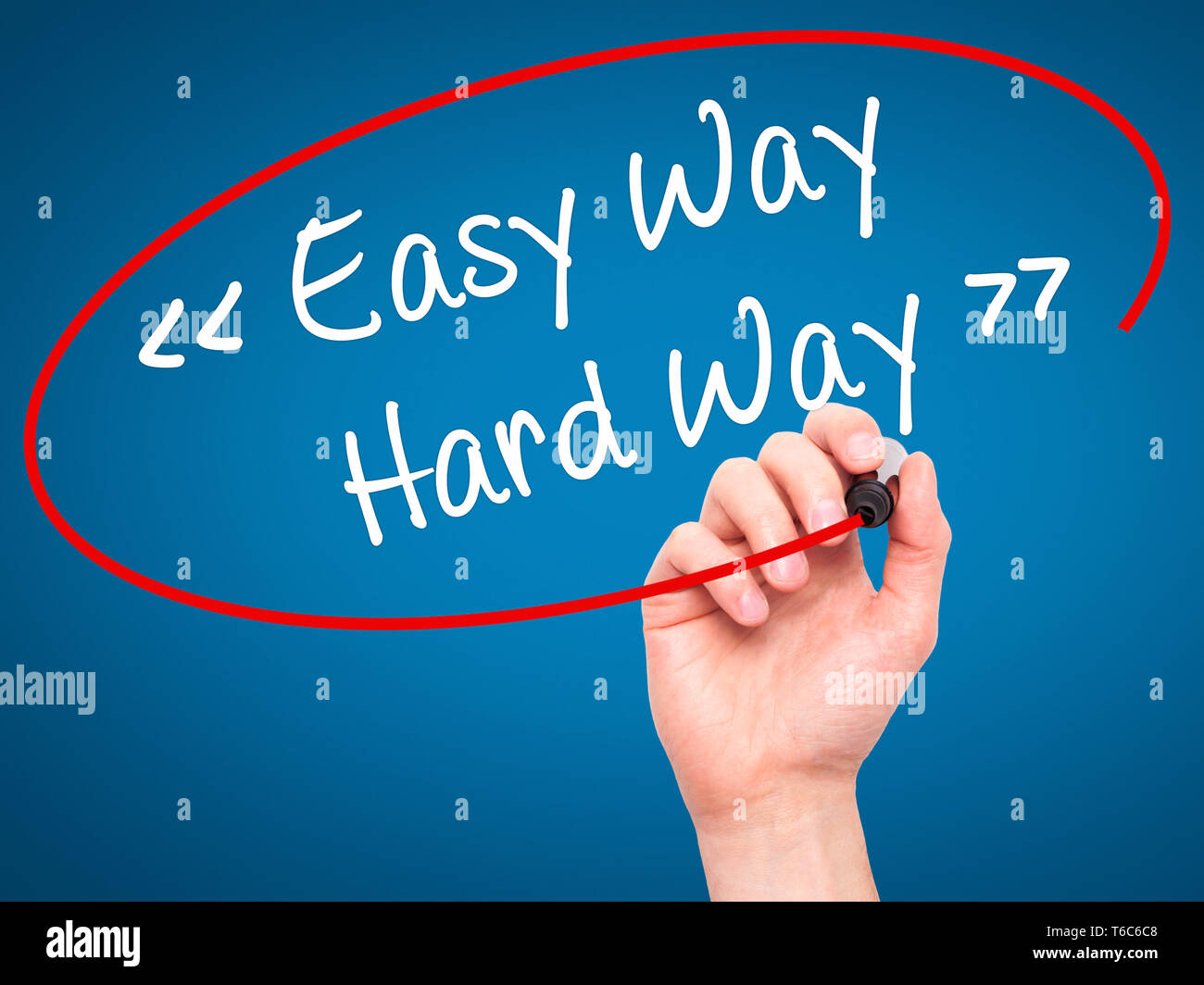 Man Hand writing Easy Way - Hard Way with black marker on visual screen ...