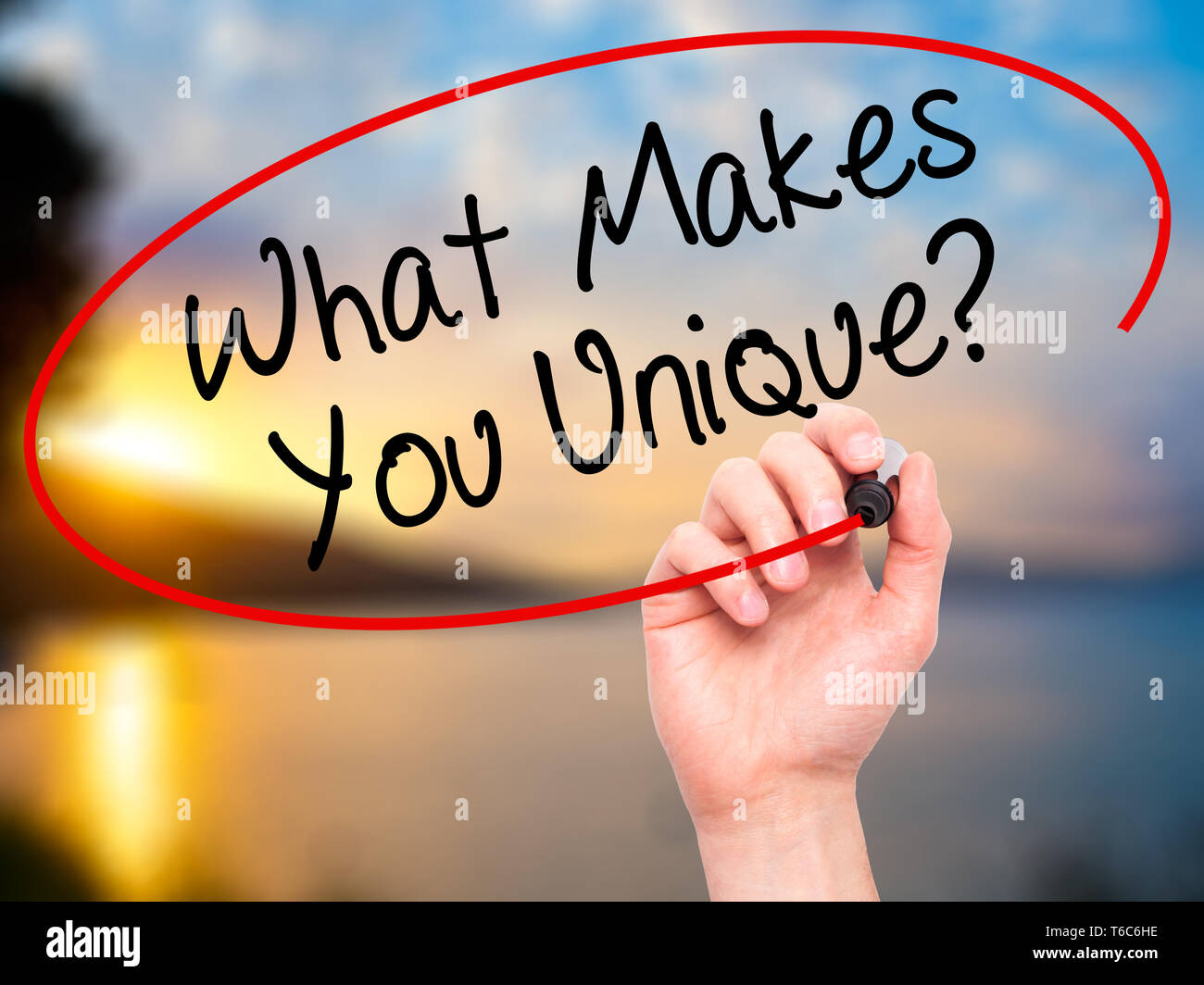 Man Hand writing What Makes You Unique? with black marker on visual ...