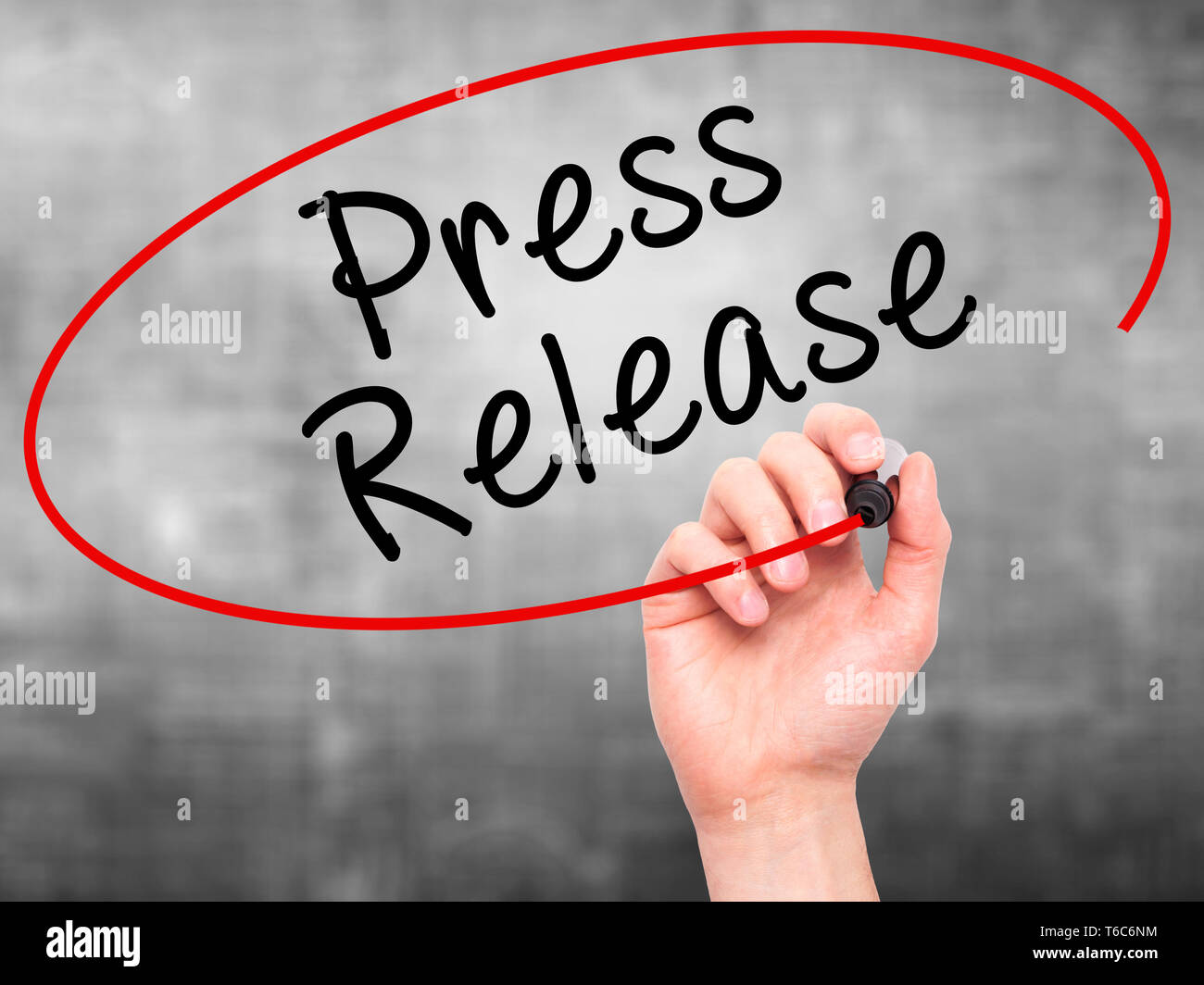 Man Hand writing Press Release with marker on transparent wipe board ...