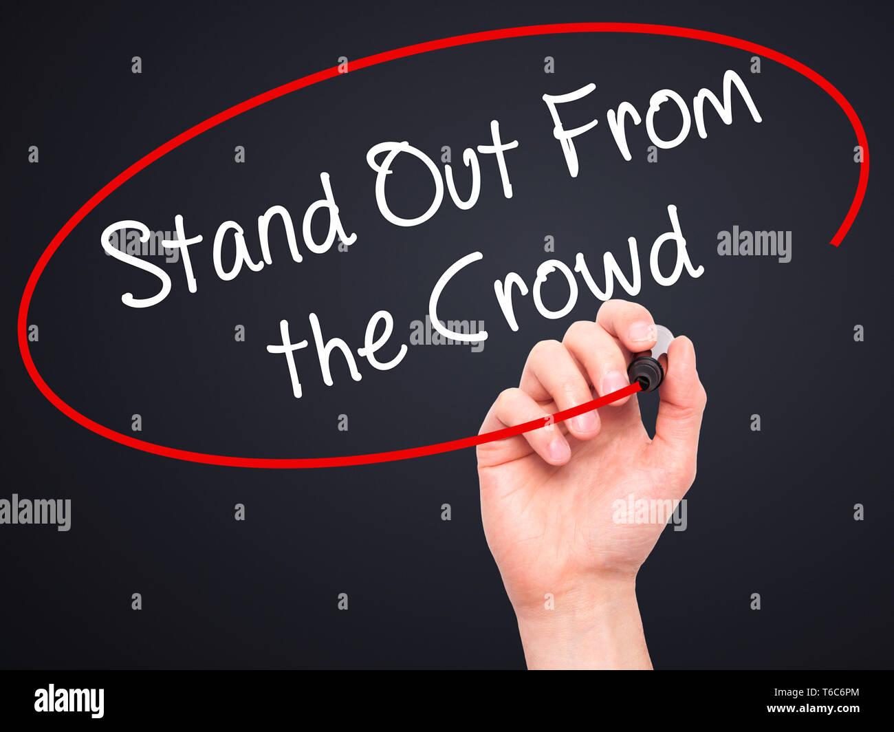 Man Hand writing Stand Out From the Crowd with black marker on visual ...