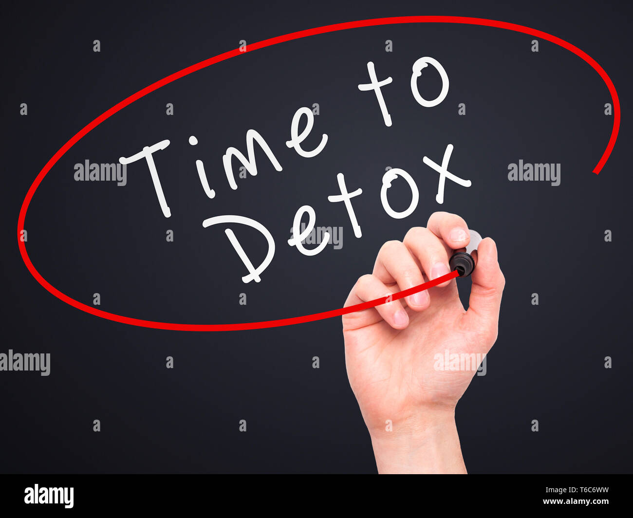 Man Hand writing Time to Detox with marker on transparent wipe board ...