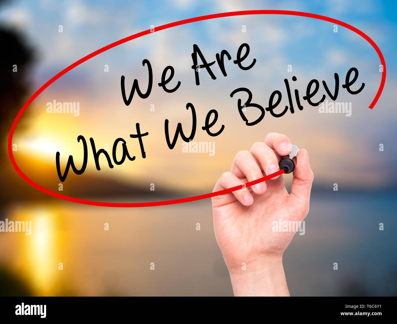 Man Hand writing We Are What We Believe with black marker on visual ...